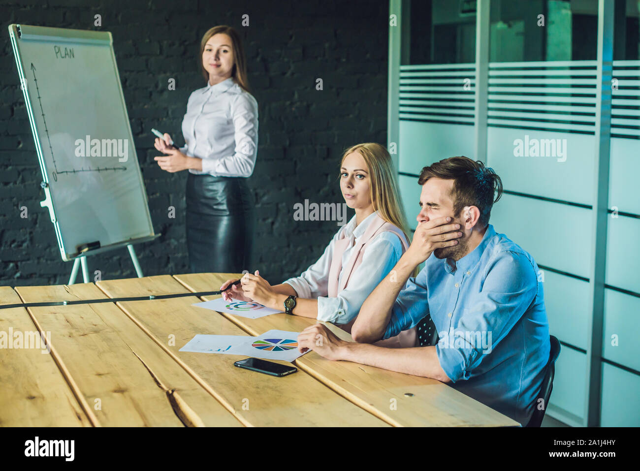 Boring presentation. Group of young business people in smart casual ...