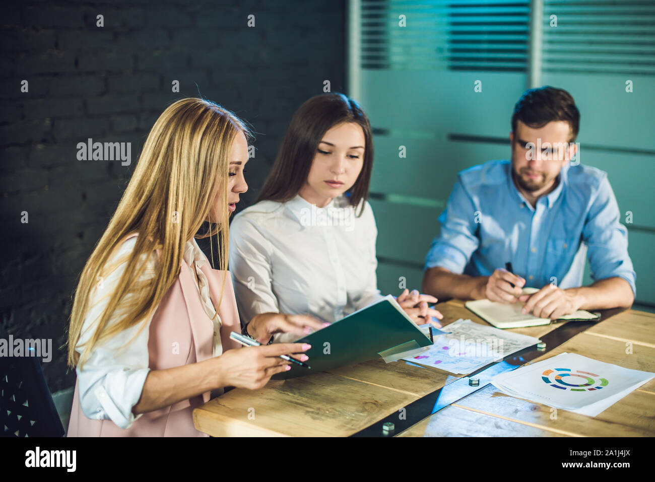 Young team of coworkers watching storyboard for shooting video in ...