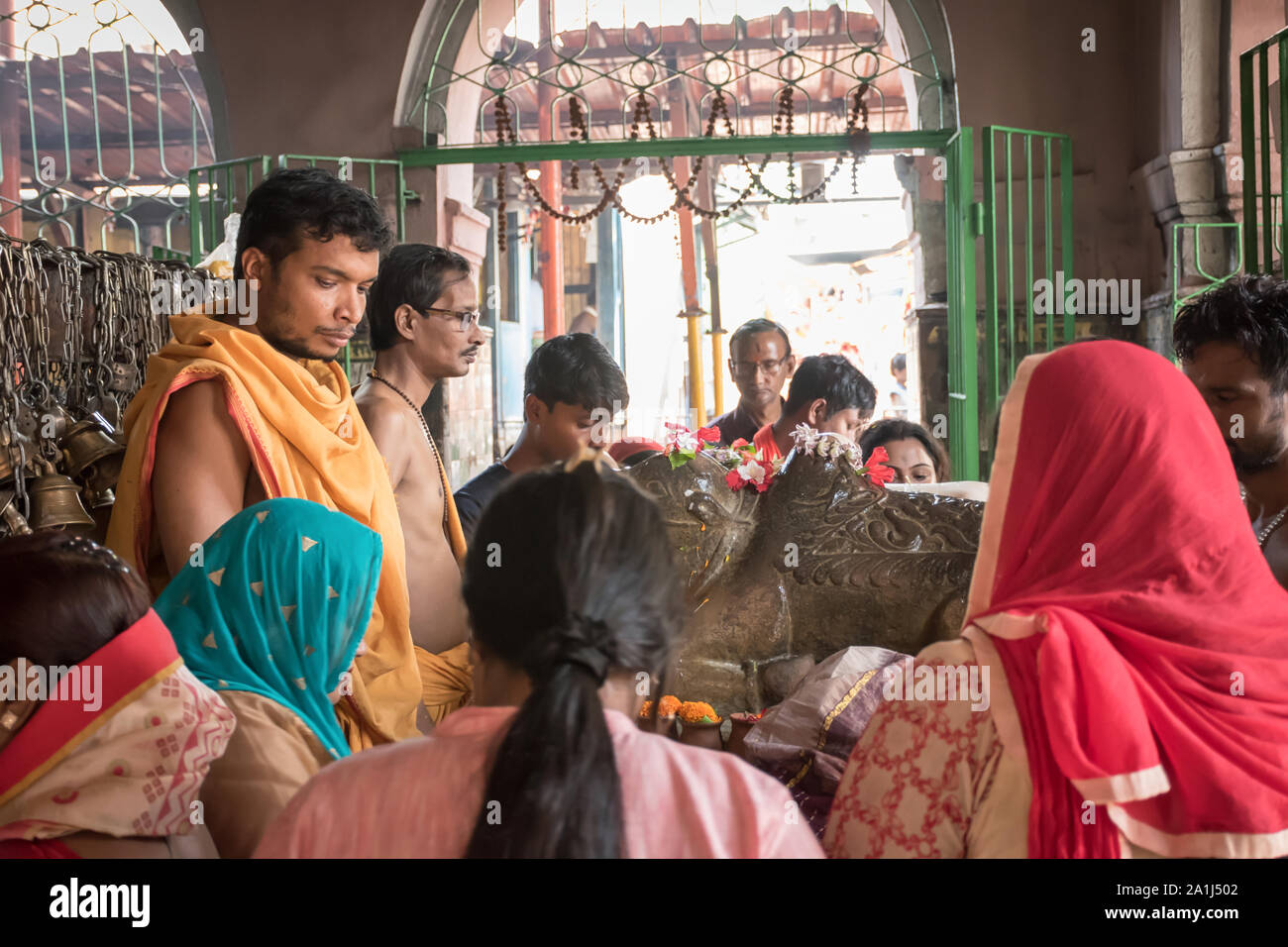 Group of people doing puja to statue of Stones at Baba Taraknath Temple ...