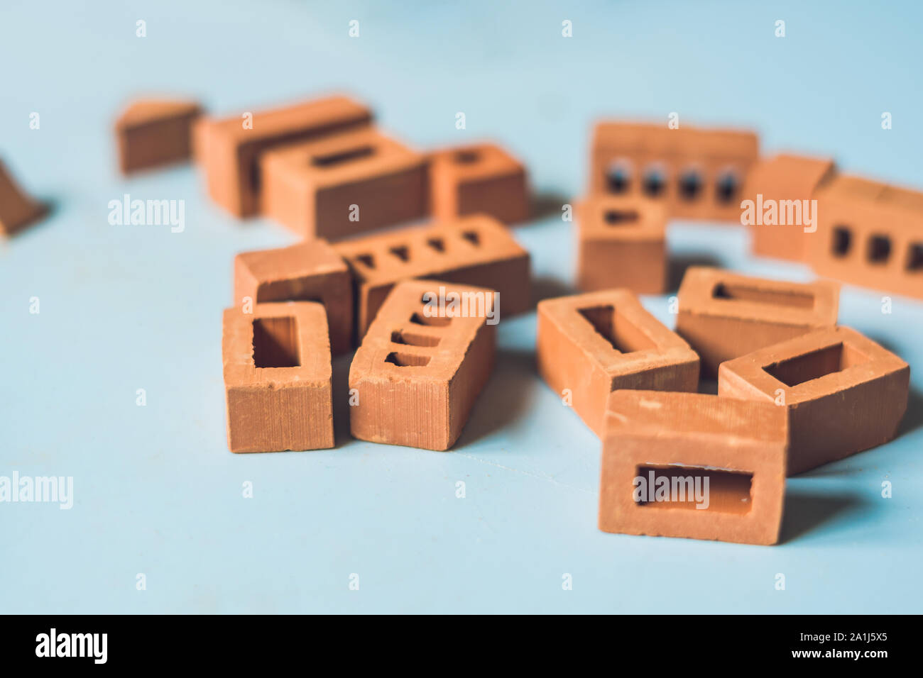 Real small clay bricks at the table. Early learning. Developing toys ...