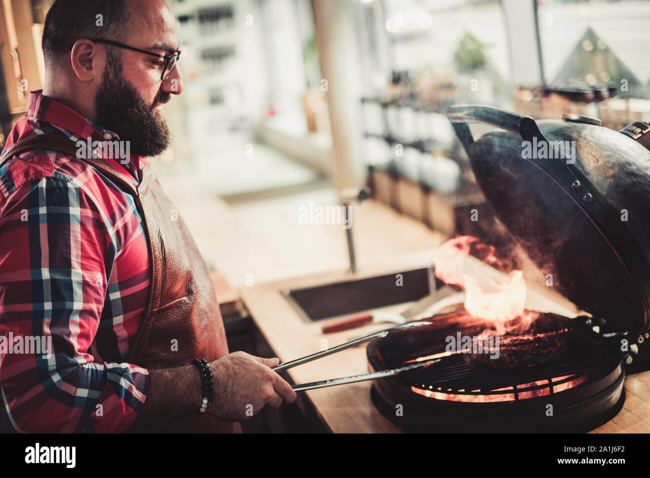 Chef grilling steak in a restaurant Stock Photo - Alamy