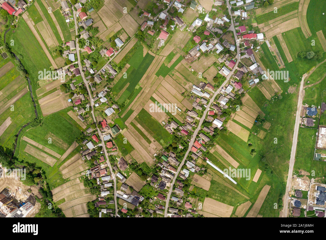 Top down aerial view of town or village with rows of buildings and ...