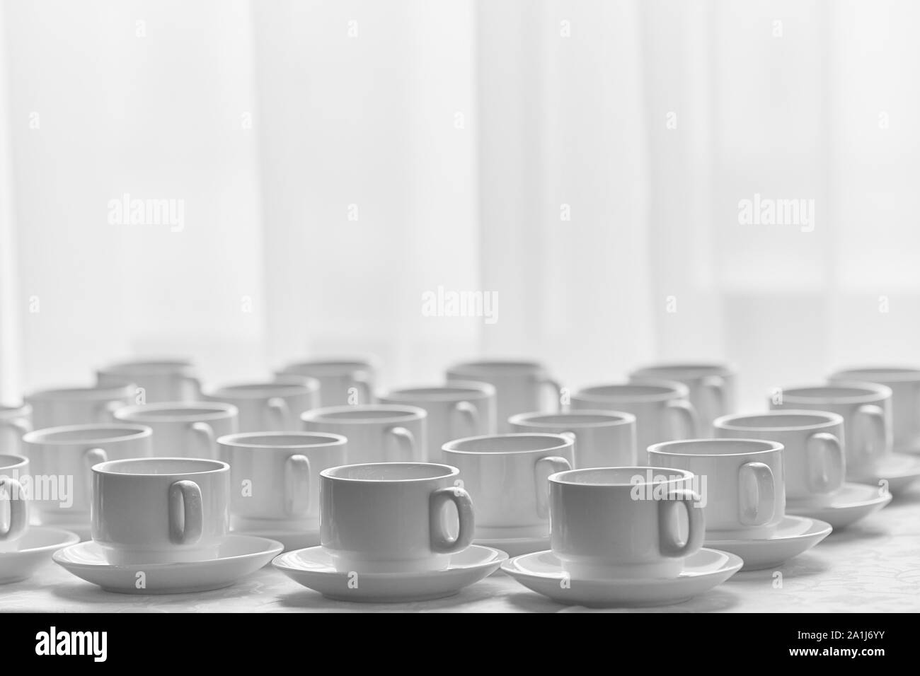 Many rows of pure white cup Black and white Stock Photo - Alamy
