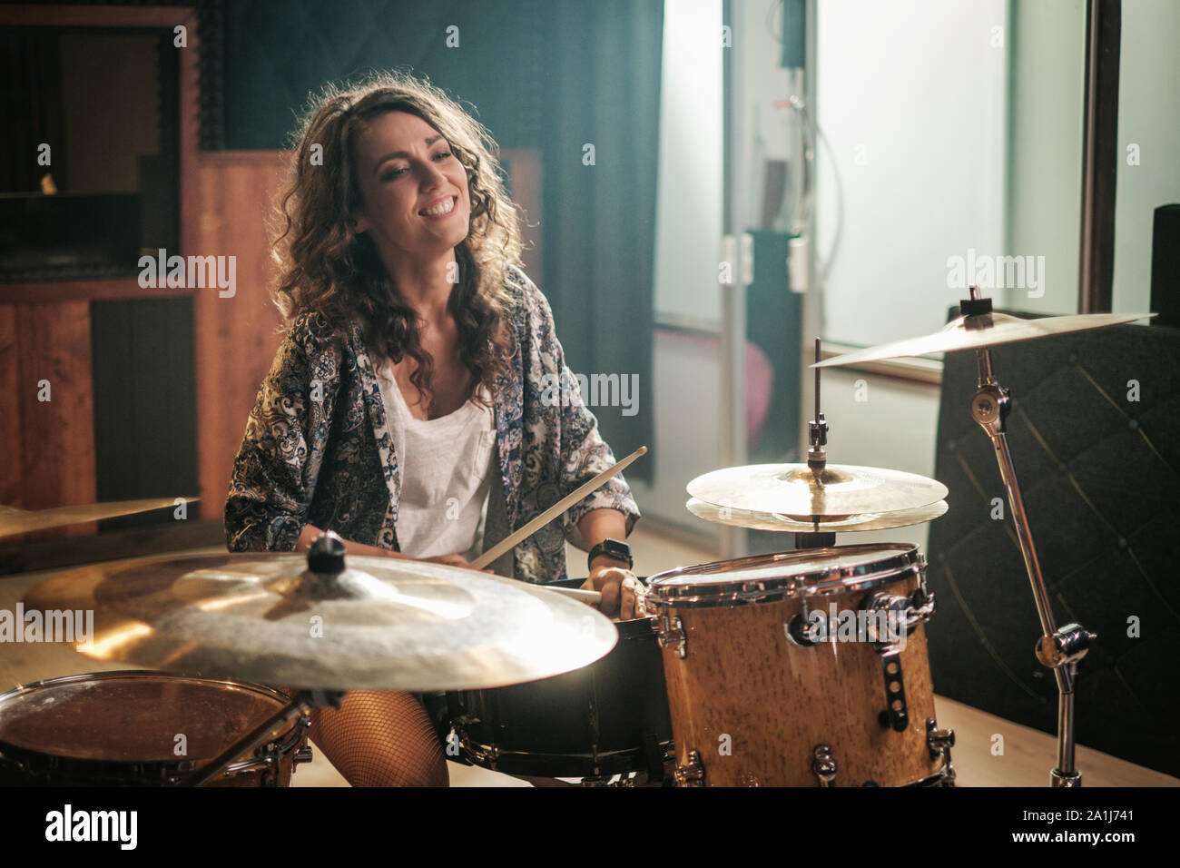 Woman playing drums during music band rehearsal Stock Photo - Alamy