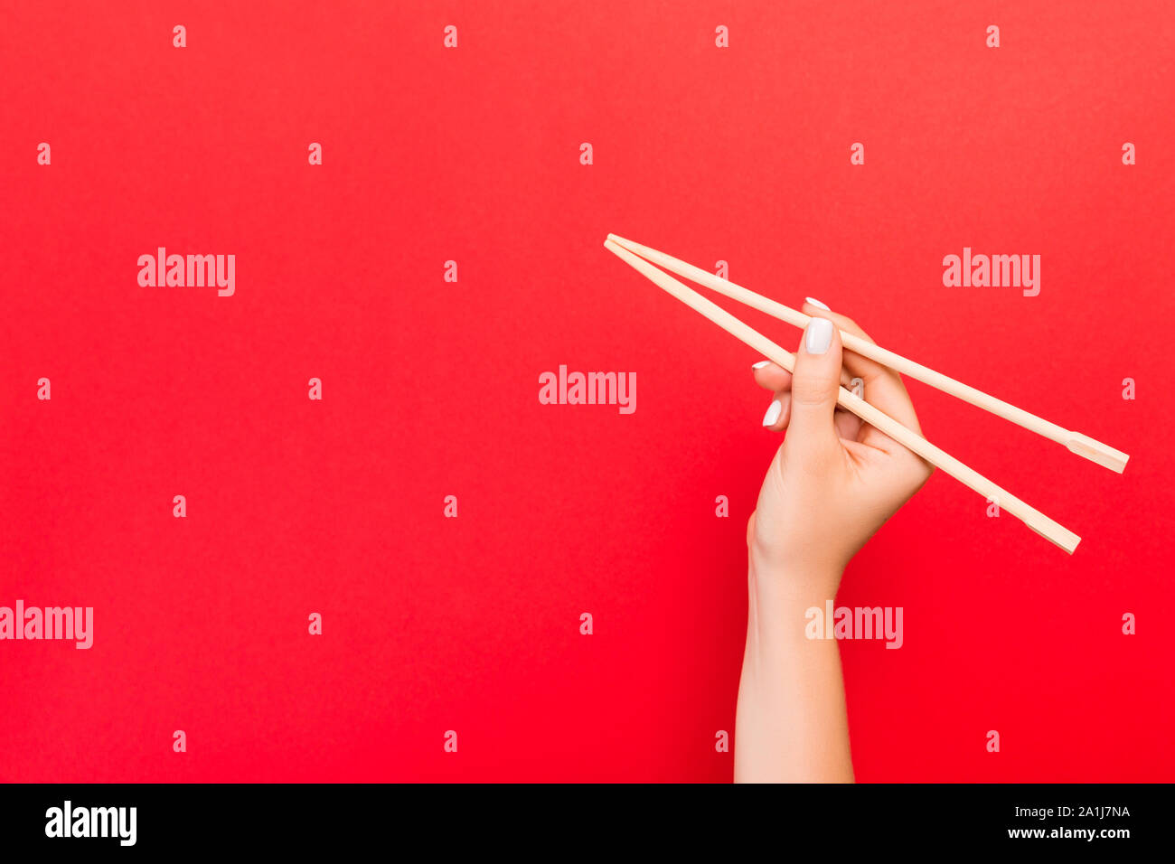 Womans hand using chopsticks hi-res stock photography and images - Alamy