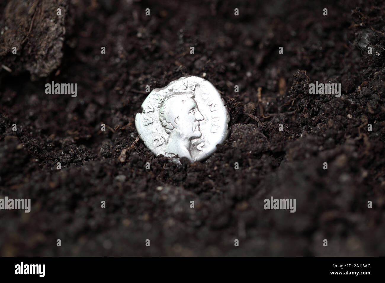 Silver denarius in the ground Stock Photo - Alamy
