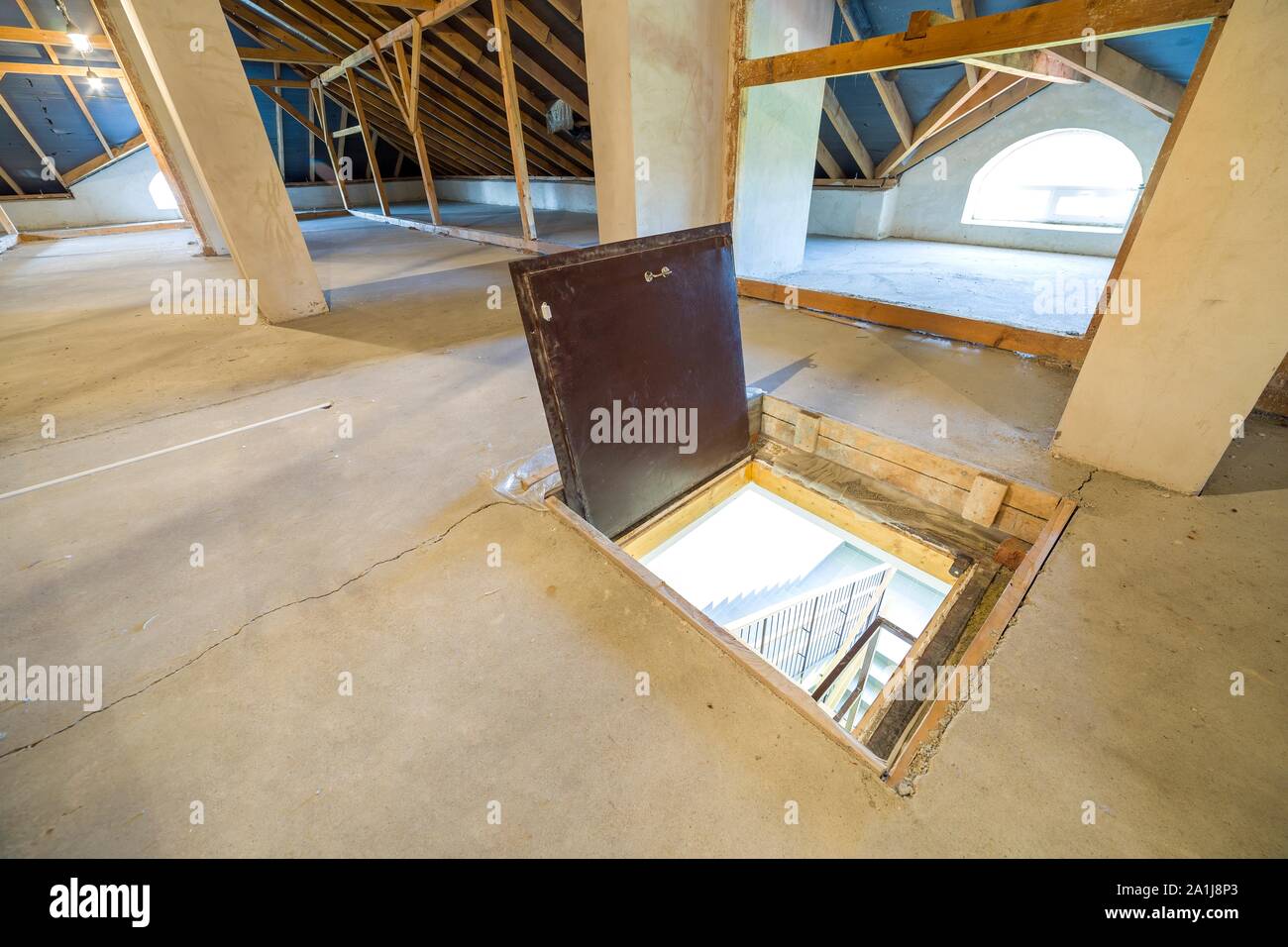 Attic of a building with wooden beams of a roof structure and a fire ...