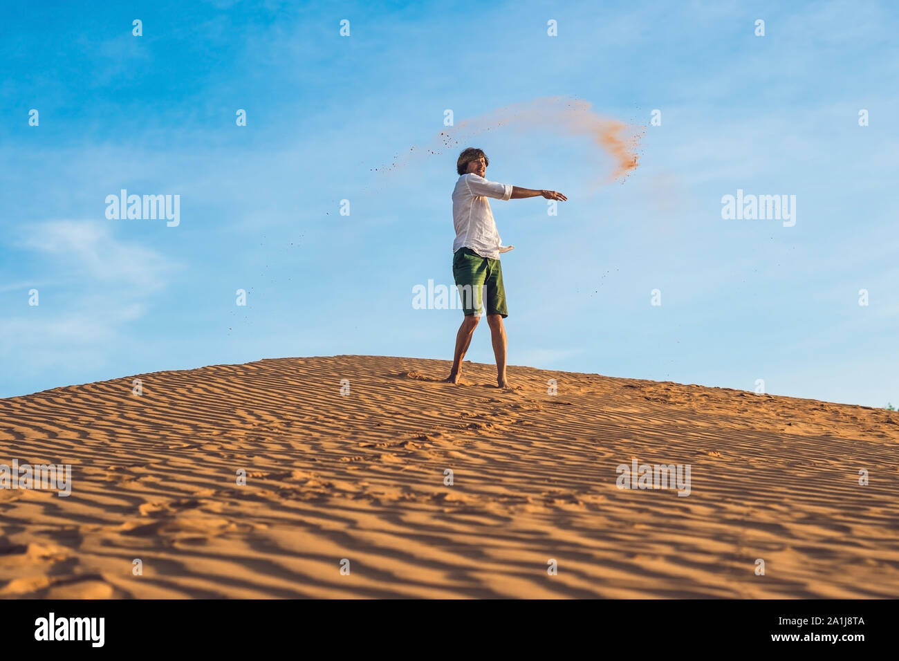 A man is kicking sand in a red desert. Splash of anger concept Stock ...