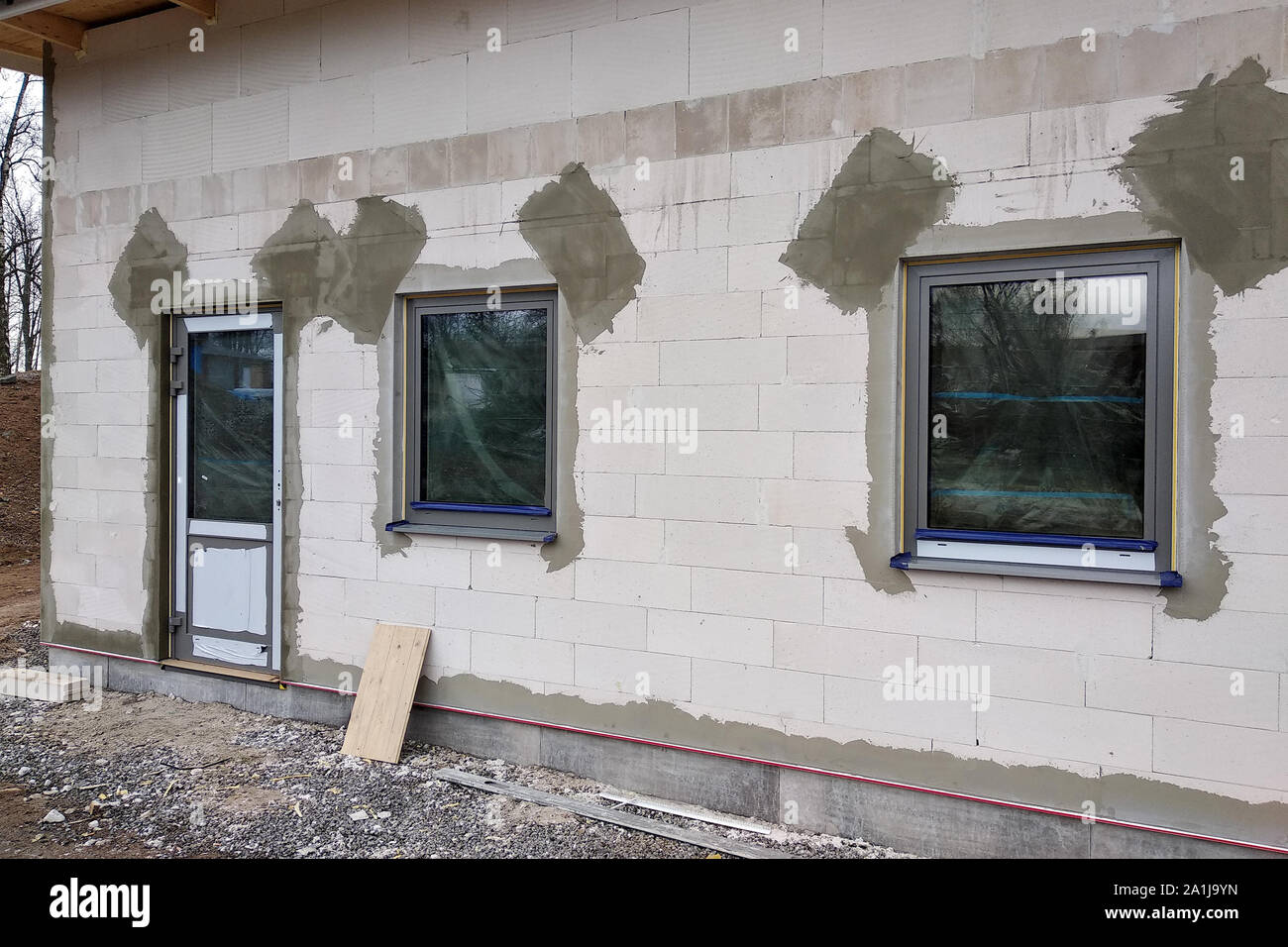 Facade of building made from white blocks with big windows under ...