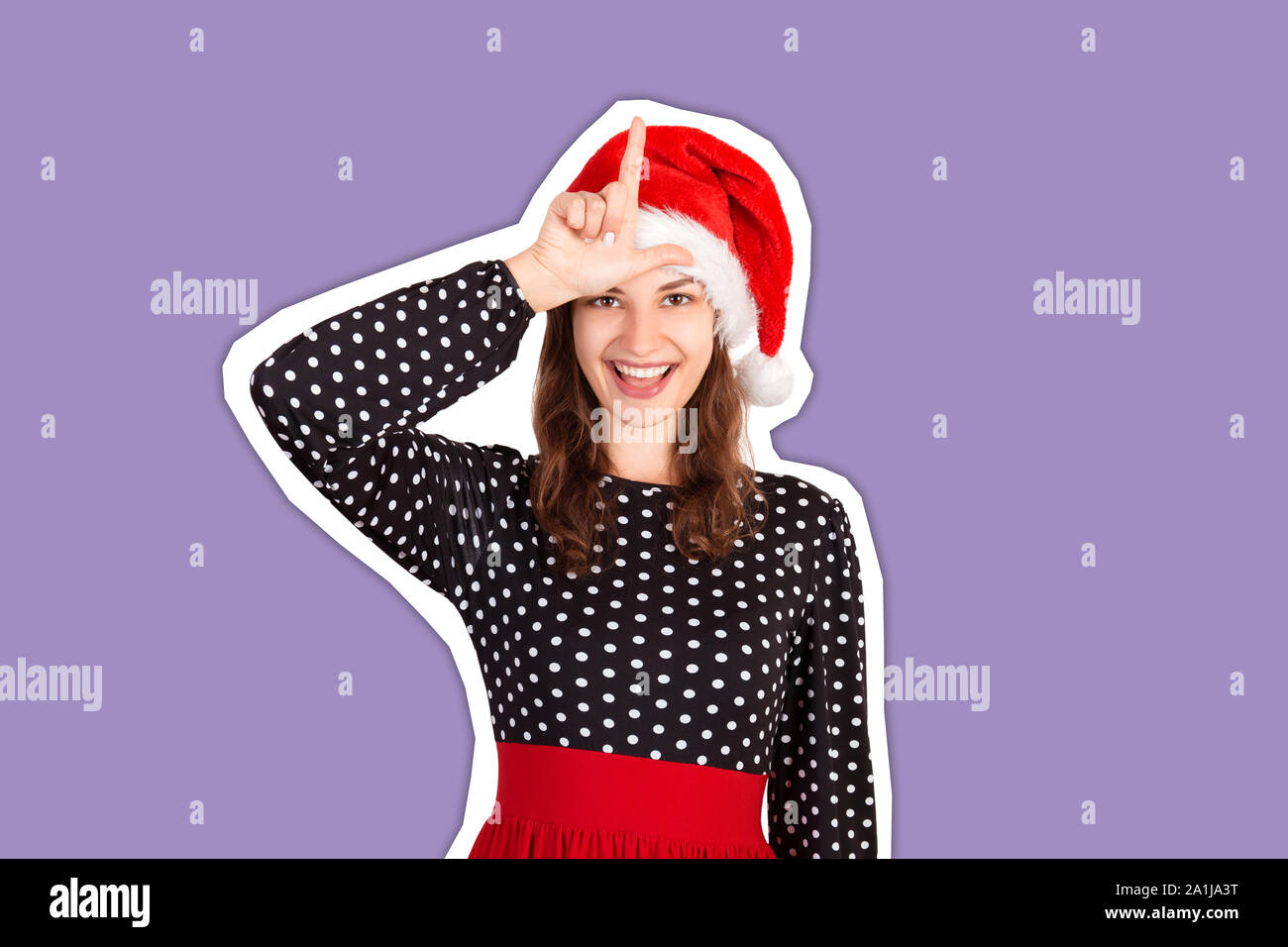 Portrait of playful crazy woman in dress holding hand showing letter L ...