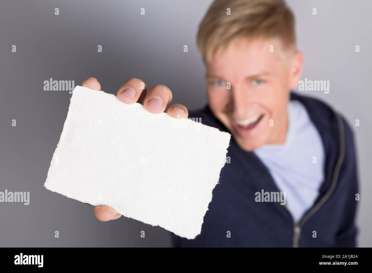 Cheerful man showing blank white card Stock Photo - Alamy