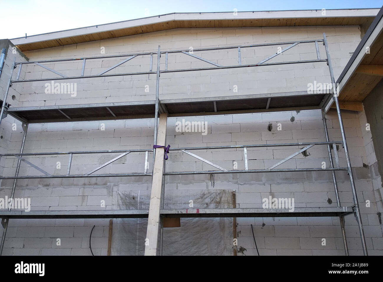Facade of white block building under construction works Stock Photo - Alamy