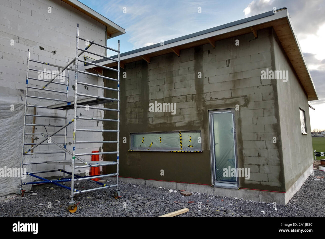 Facade of white block building under construction works Stock Photo - Alamy