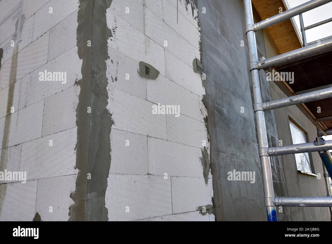Facade of white block building under construction works Stock Photo - Alamy