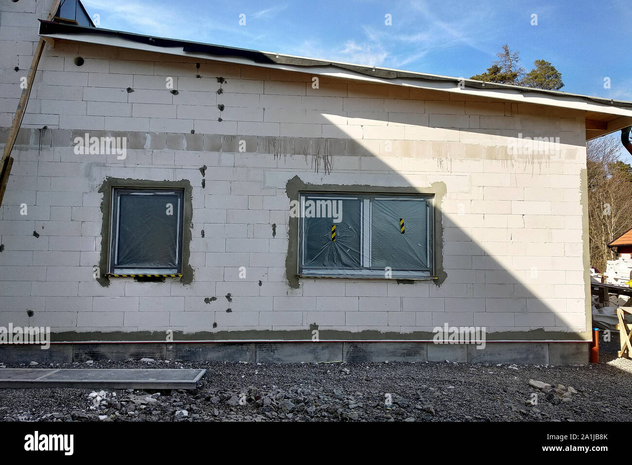 Facade of white block building under construction works Stock Photo - Alamy