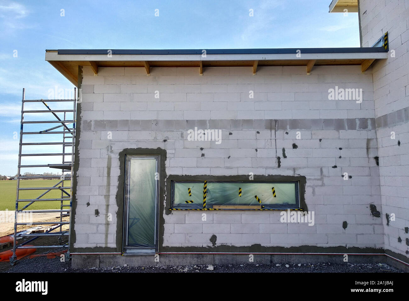Facade of white block building under construction works Stock Photo - Alamy