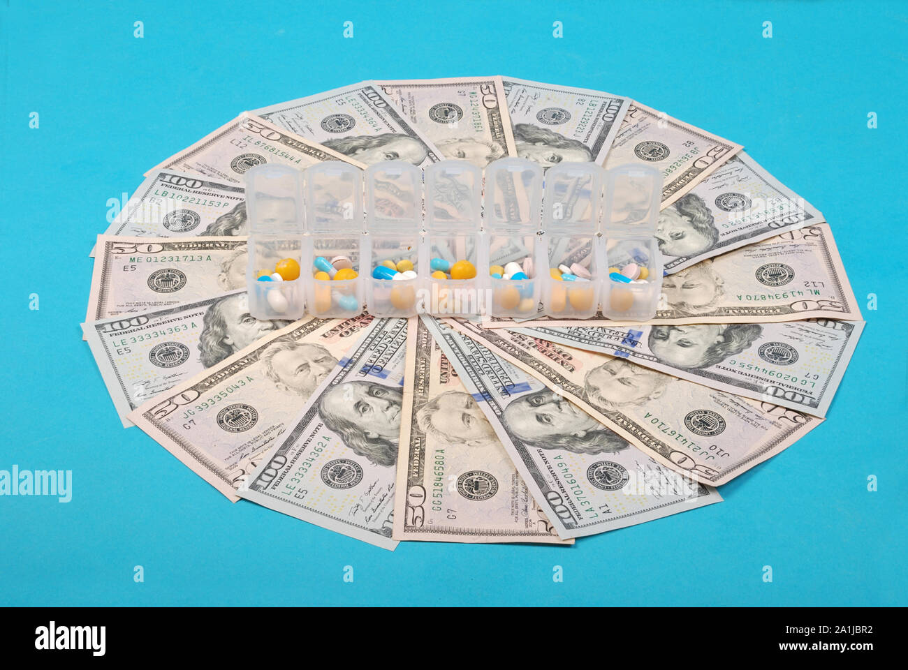 Colored capsules in open box on money, in the shape of a circle ...