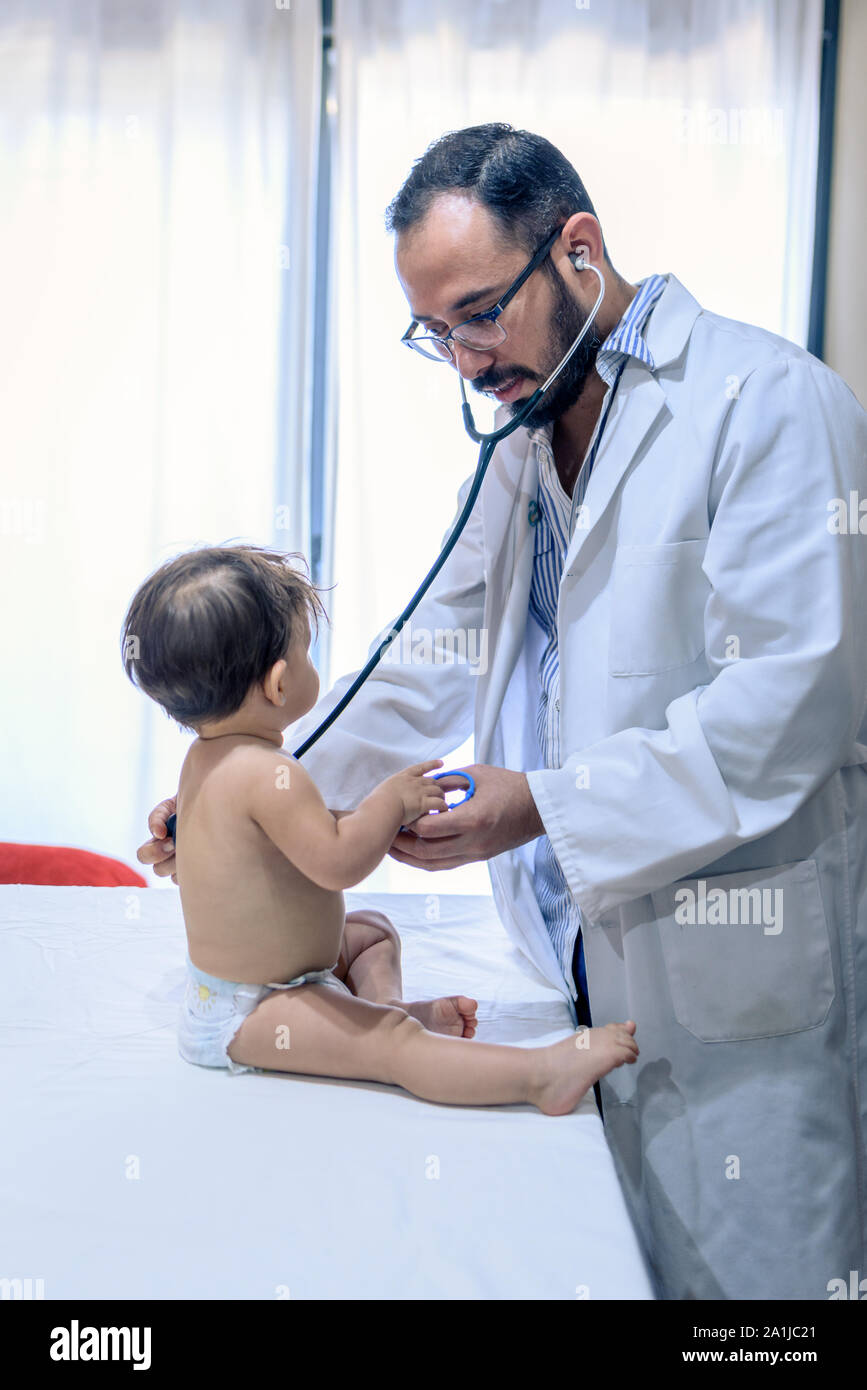 Doctor observing a one-year-old baby Stock Photo - Alamy