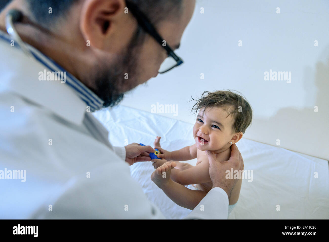 Doctor observing a one-year-old baby Stock Photo - Alamy