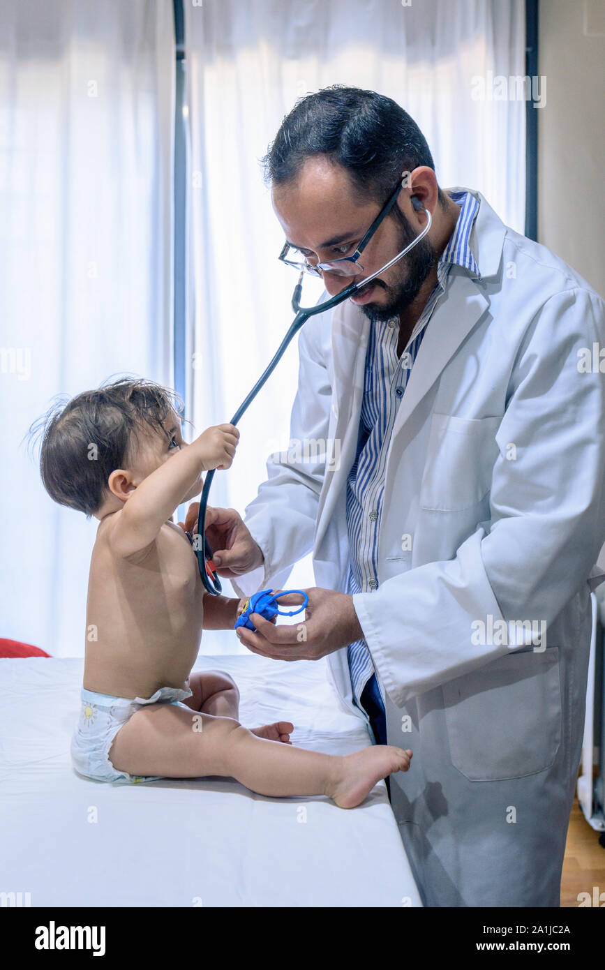 Doctor observing a one-year-old baby Stock Photo - Alamy