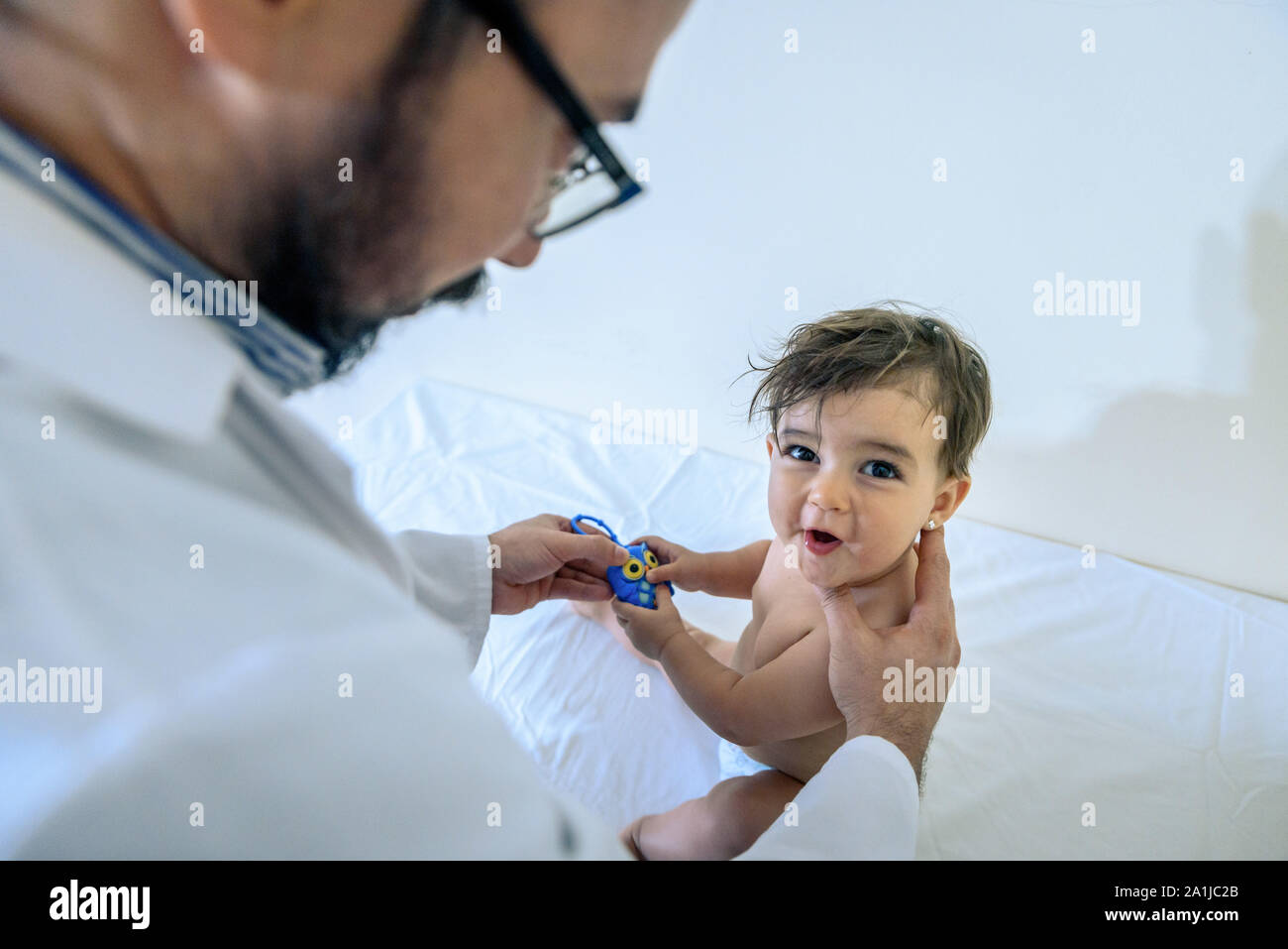 Doctor observing a one-year-old baby Stock Photo - Alamy