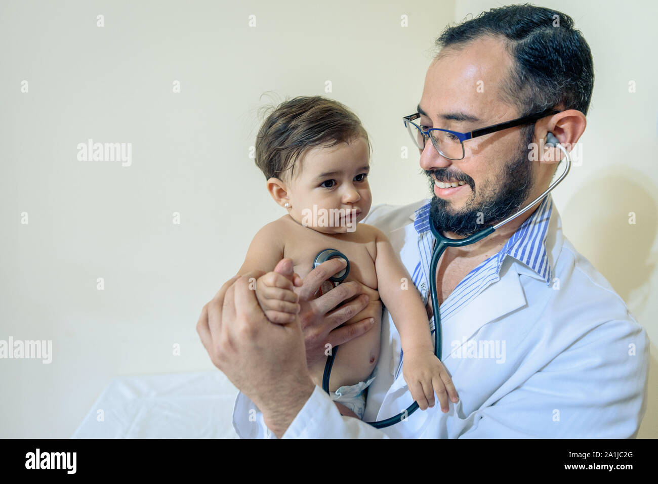 Doctor observing a one-year-old baby Stock Photo - Alamy