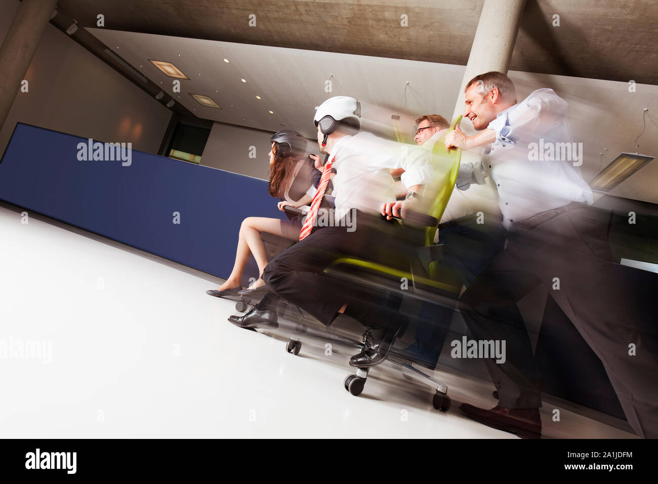 Teams in office chair race Stock Photo - Alamy