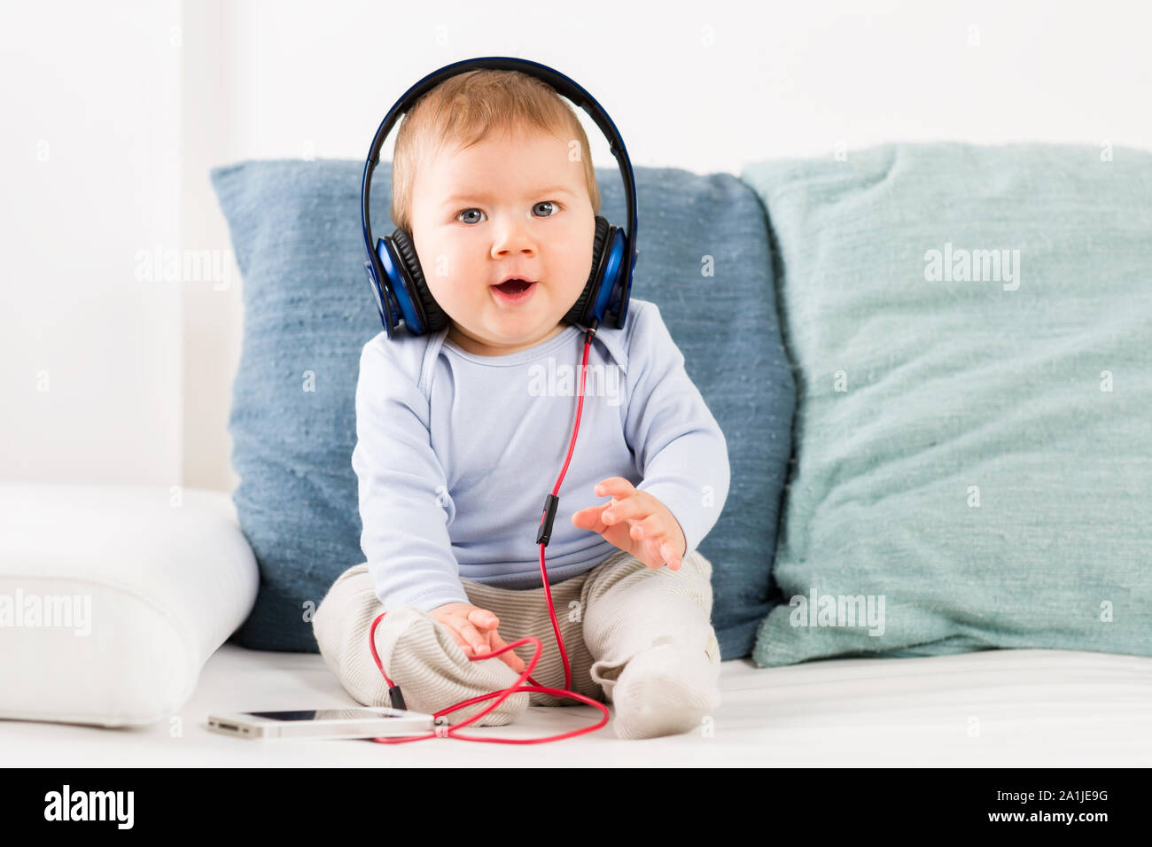 Cute baby boy listening music at headphones Stock Photo - Alamy