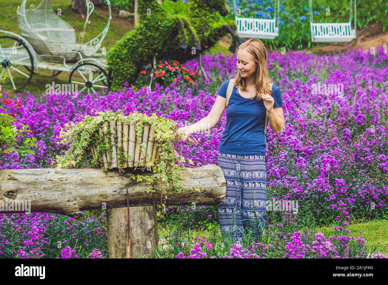 Happy woman enjoying smell flowers over spring garden background Stock ...