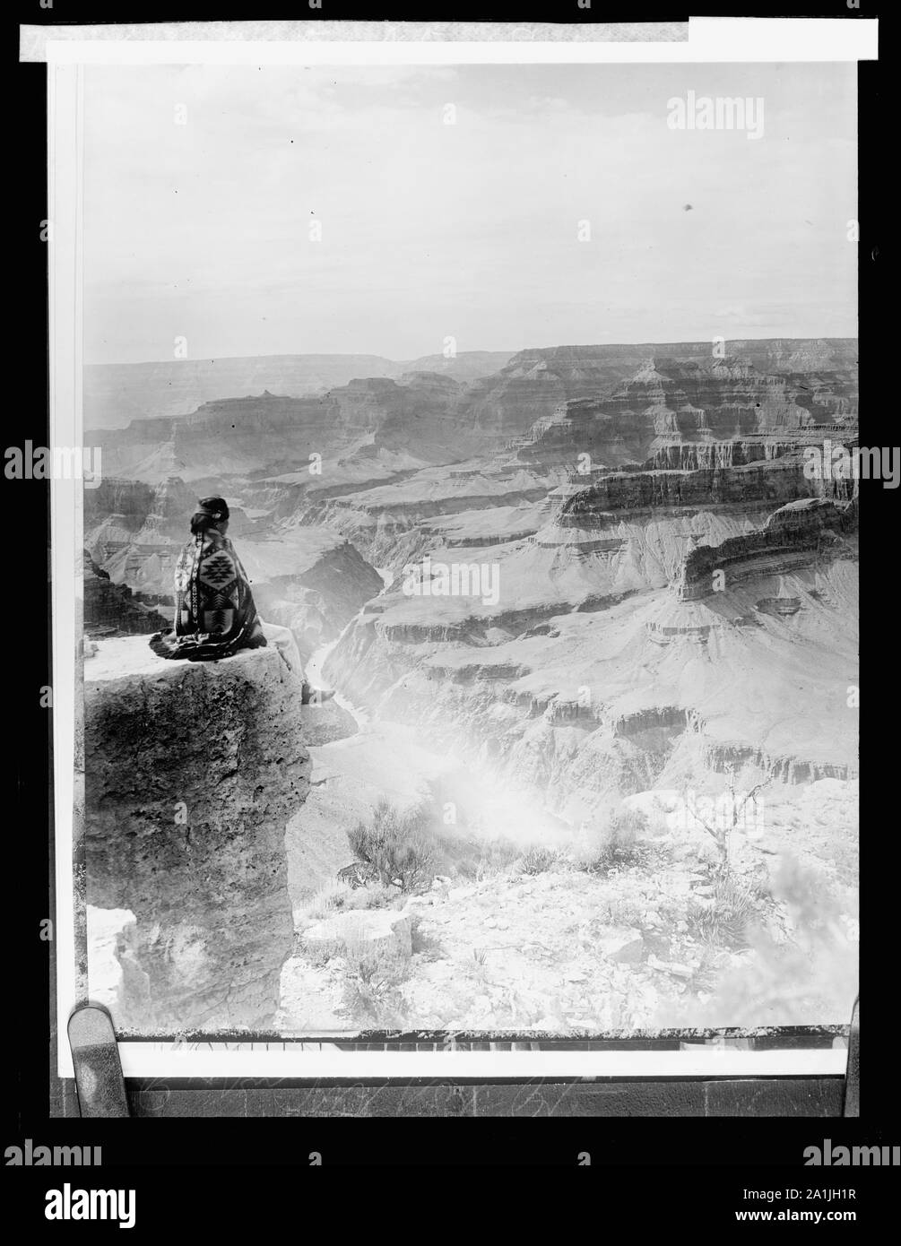 Native American seated on the edge of the Grand Canyon, Arizona Stock ...