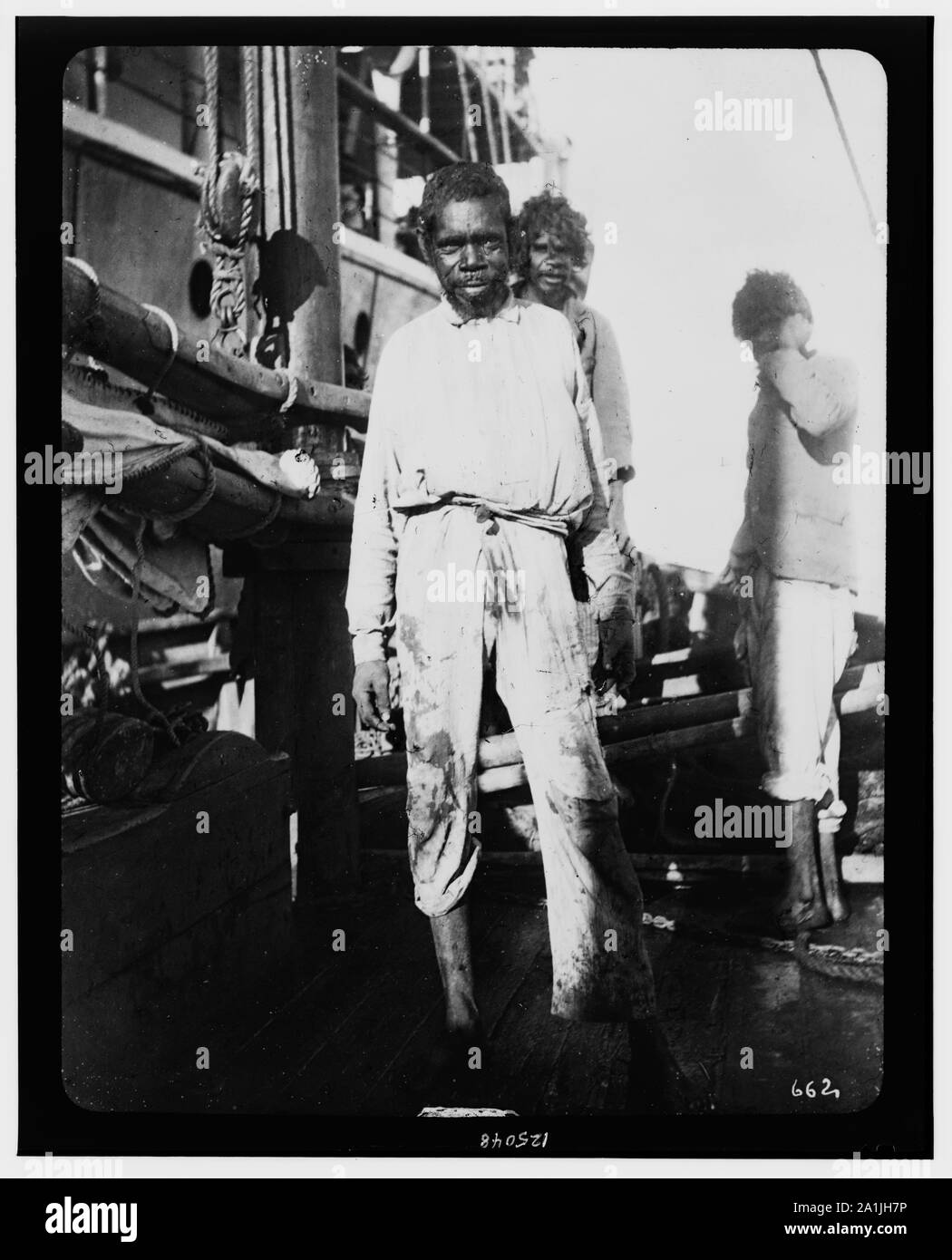Native crewmen on deck of ship Stock Photo - Alamy