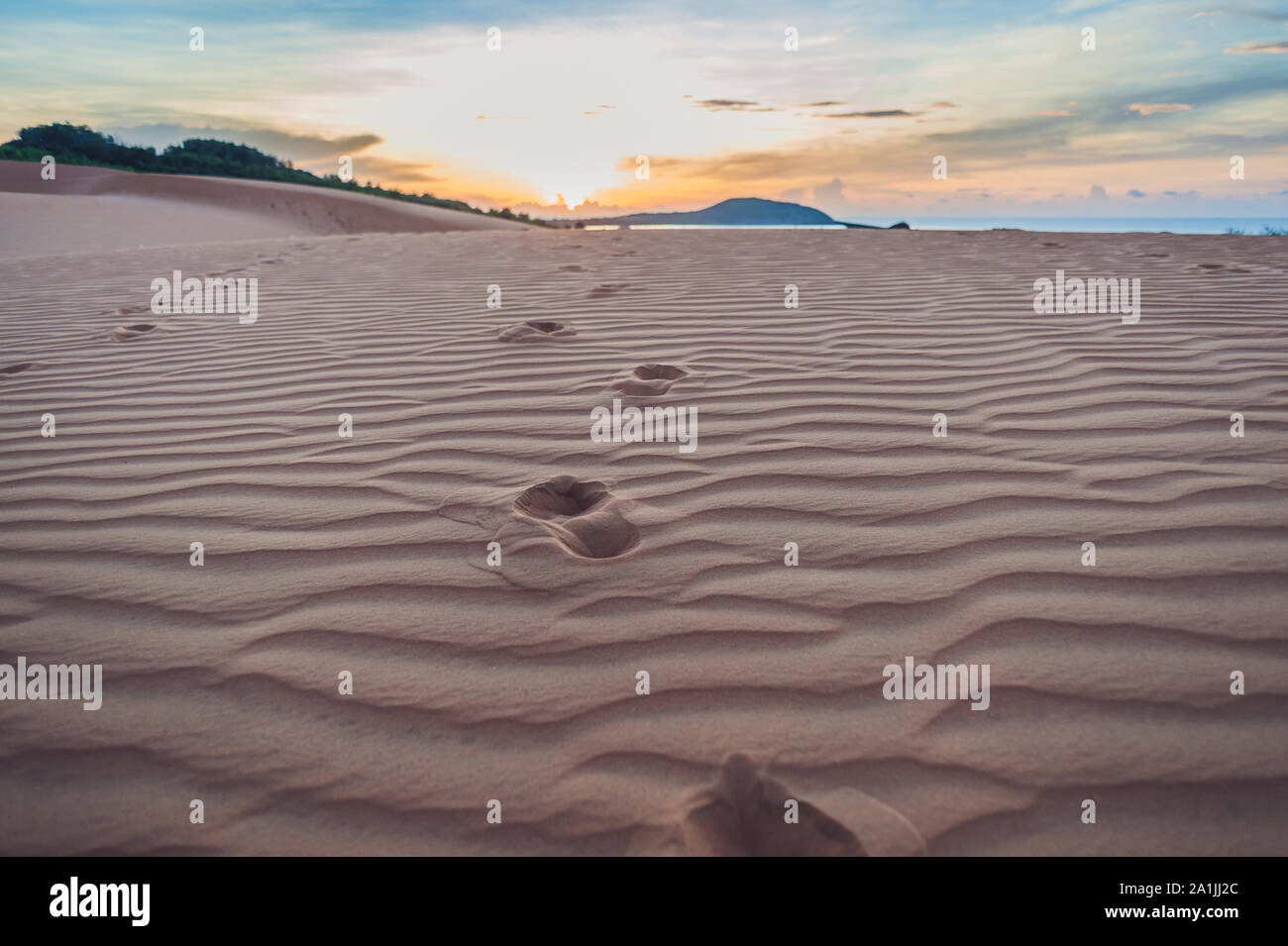 Footprints in the sand in the red desert at Sunrise Stock Photo - Alamy