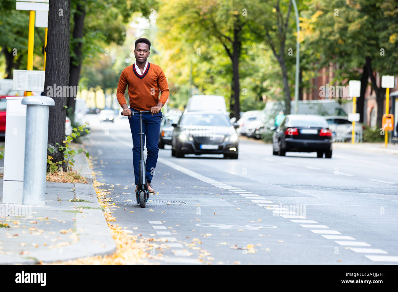Young African Man Riding An Electric Scooter Stock Photo - Alamy