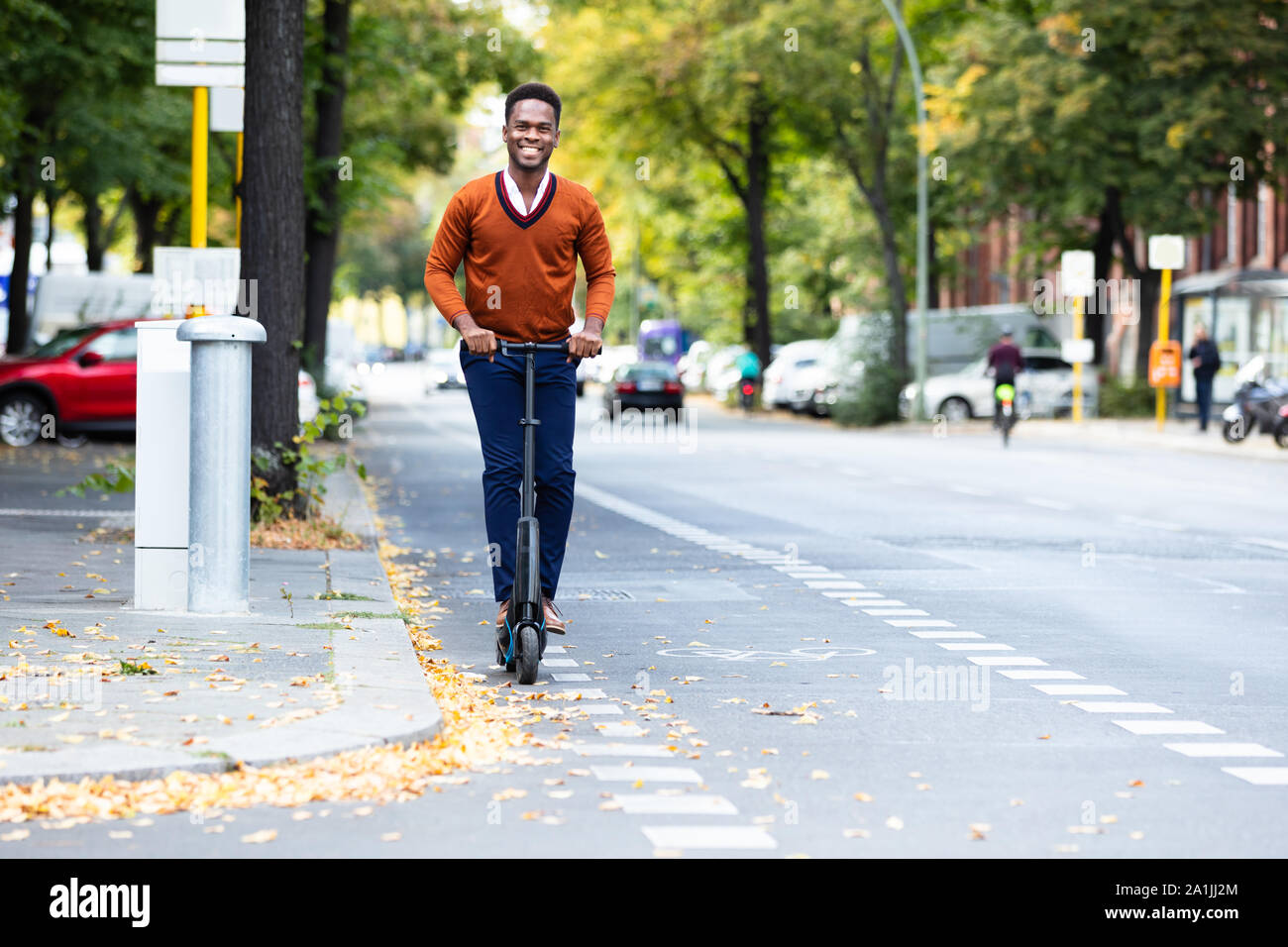 Young African Man Riding An Electric Scooter Stock Photo - Alamy
