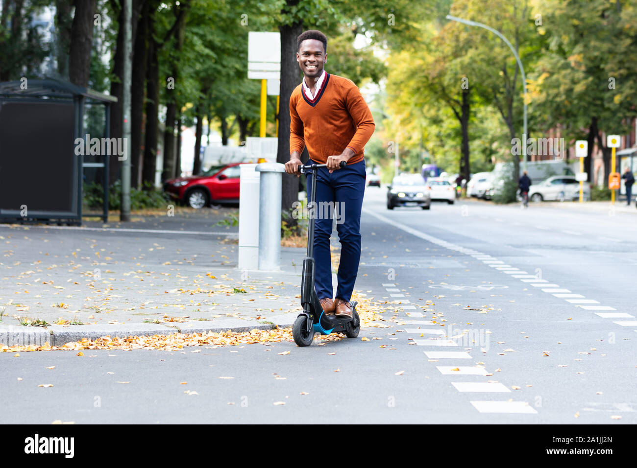 Young African Man Riding An Electric Scooter Stock Photo - Alamy