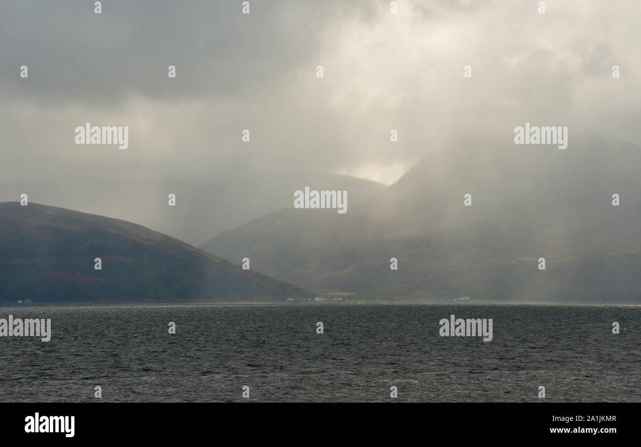 Rain showers sweeping over coastal mountains of Isle of Arran. Scotland ...