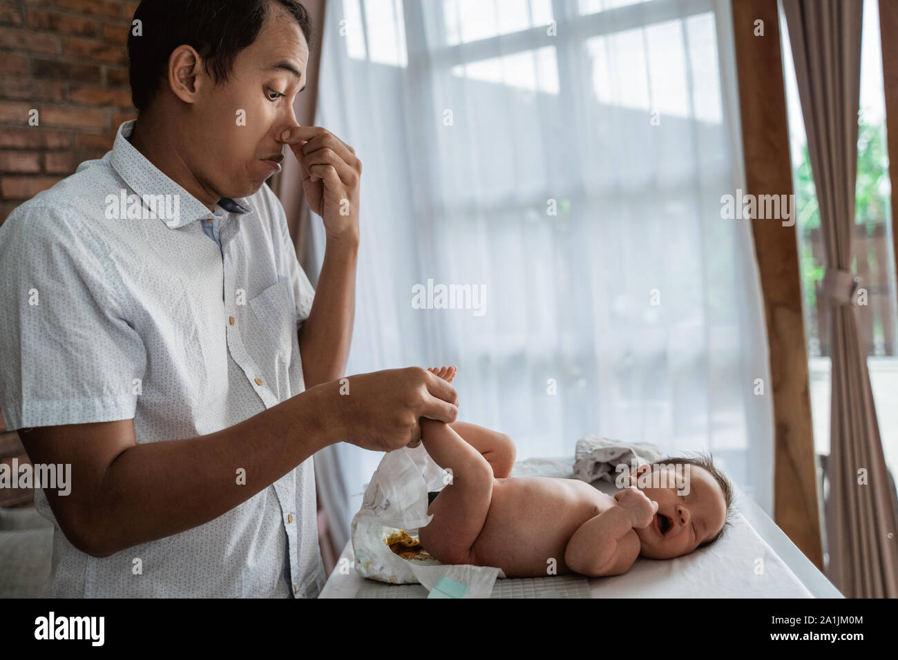 asian father change baby diapers Stock Photo - Alamy