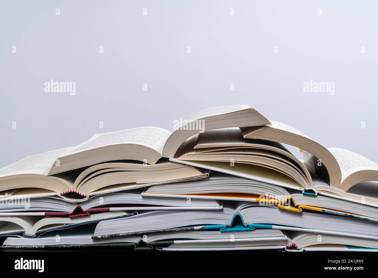 a stack of open books with a white background Stock Photo - Alamy