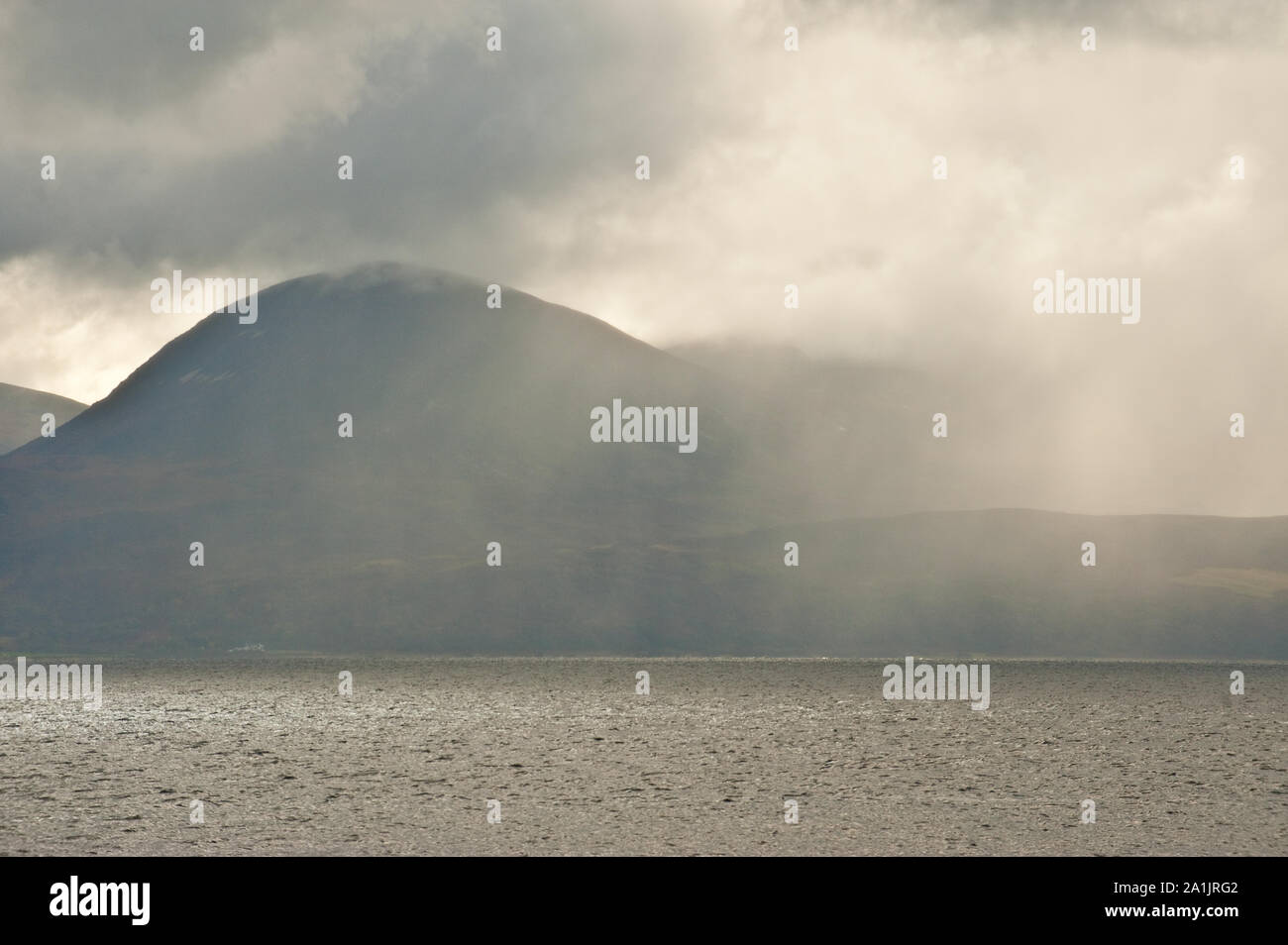 Rain showers sweeping over coastal mountains of Isle of Arran. Scotland ...