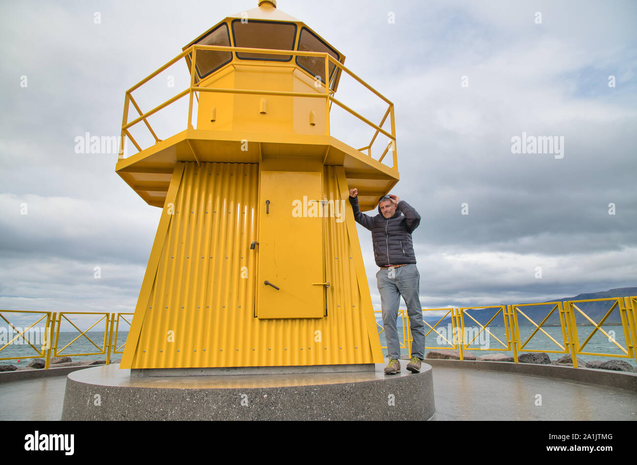 Man standing and touching Hofdi House in Reykjavik Stock Photo - Alamy