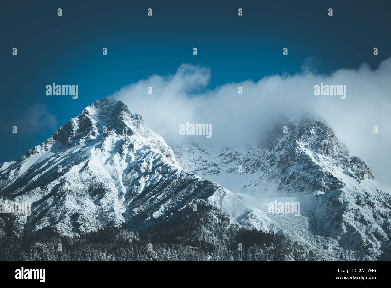 Epic snowy mountain peak with clouds in winter, landscape, alps ...