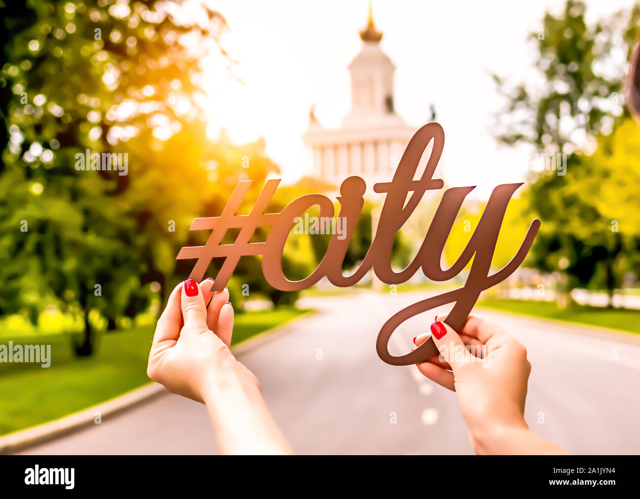 women holds city sign behind the beautiful sunset light Stock Photo - Alamy