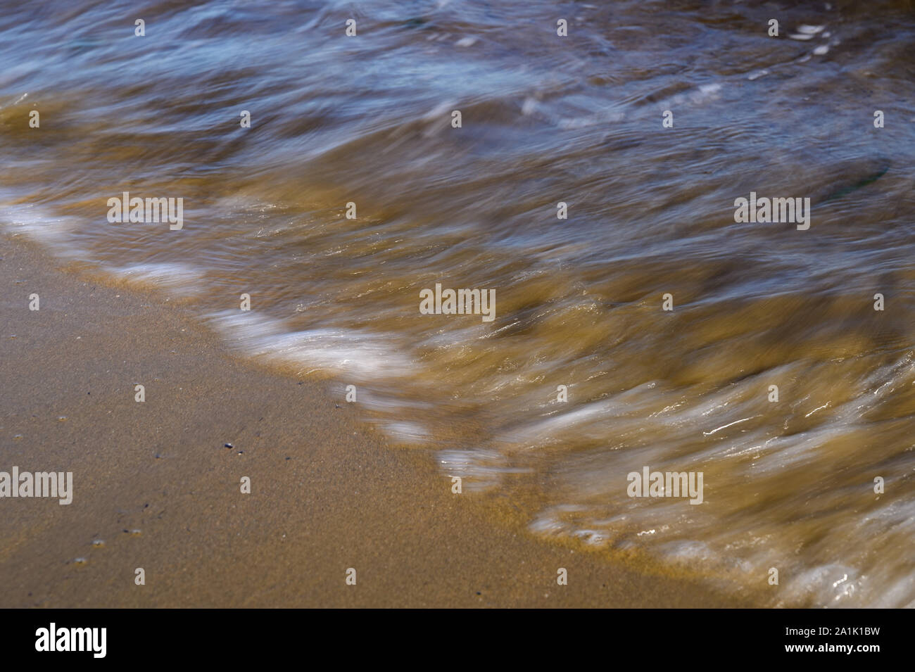 Waves on the seashore captured with a slow shutter speed. Natural ...