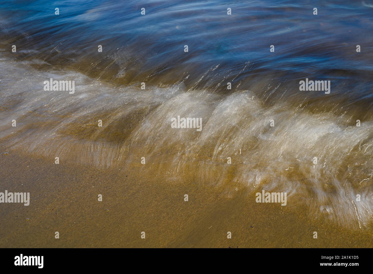 Waves on the seashore captured with a slow shutter speed. Natural ...