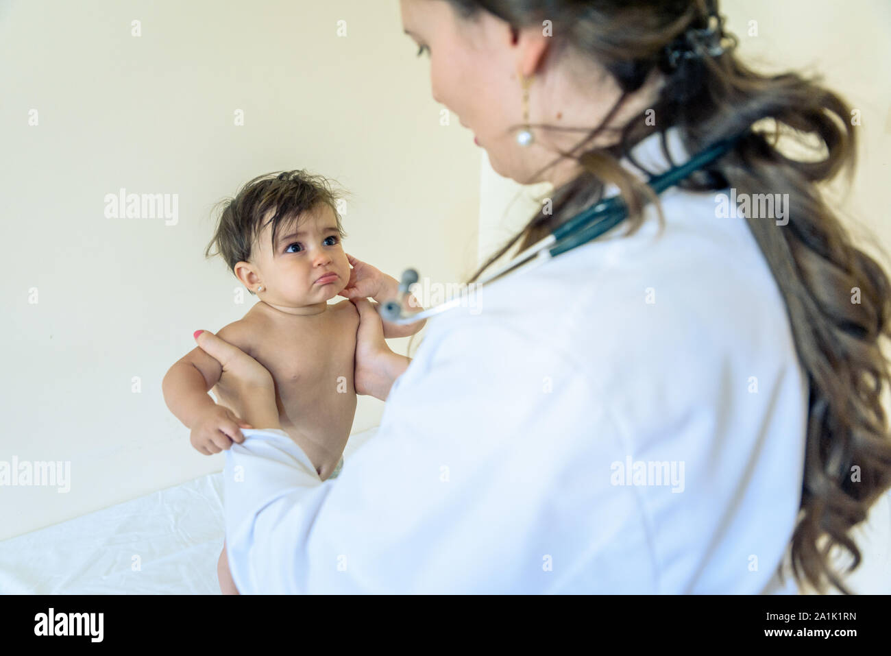 Doctor passing a baby girl's check-up at the hospital Stock Photo - Alamy