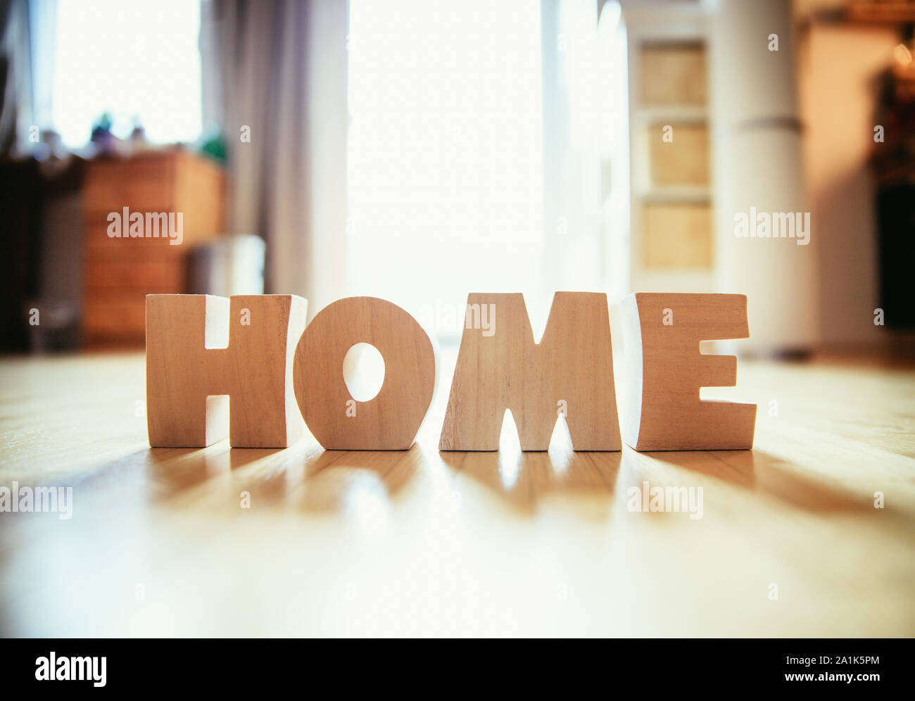 Wooden HOME Letters on the floor of an apartment Stock Photo - Alamy