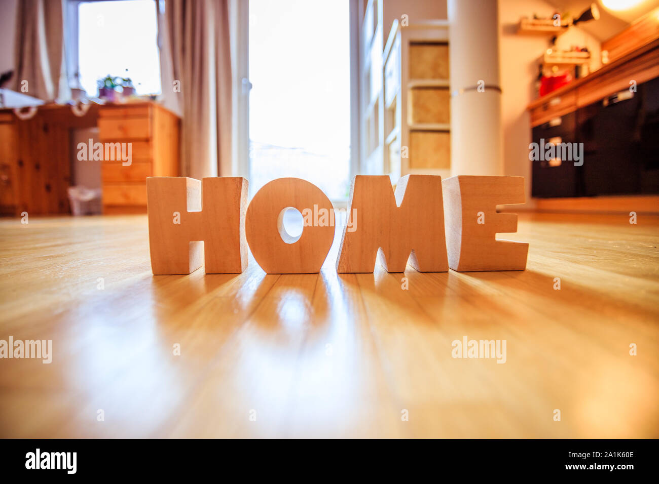 Wooden HOME Letters on the floor of an apartment Stock Photo - Alamy