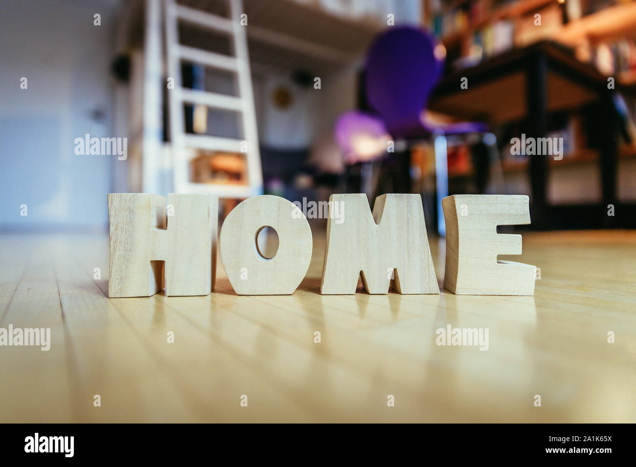 Wooden HOME Letters on the floor of an apartment Stock Photo - Alamy