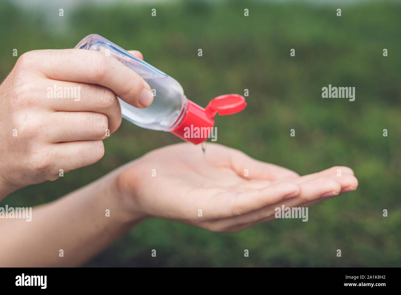 Pouring gel to clean hands with sanitizer antiseptic gel hi-res stock ...