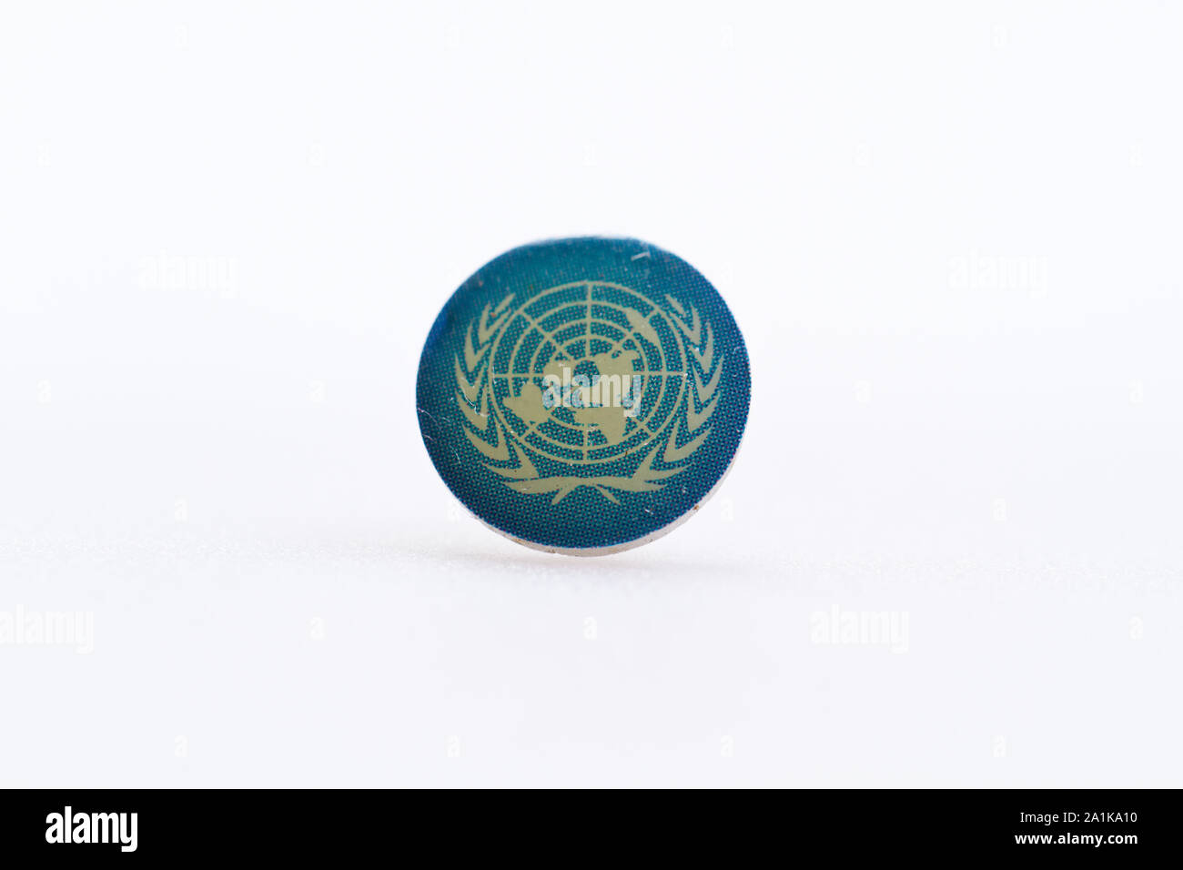 United Nation flag symbol on metal thumbtack on white surface Stock ...